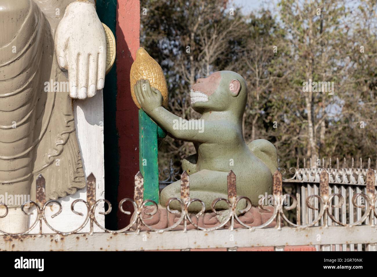 The statue of a monkey beside the statue of Buddha at Shreenagar ...