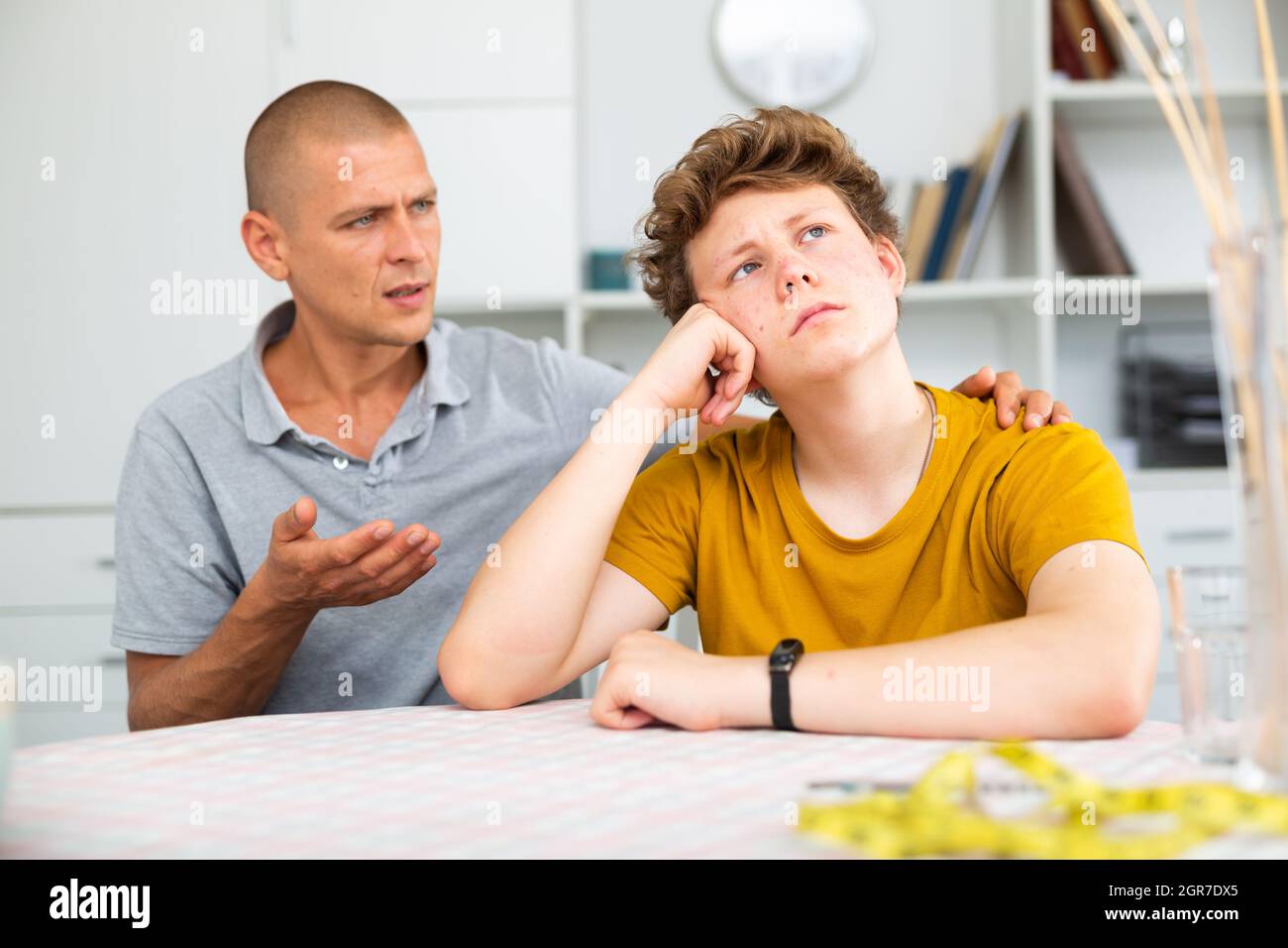 Son feeling sad and father talking to him Stock Photo - Alamy