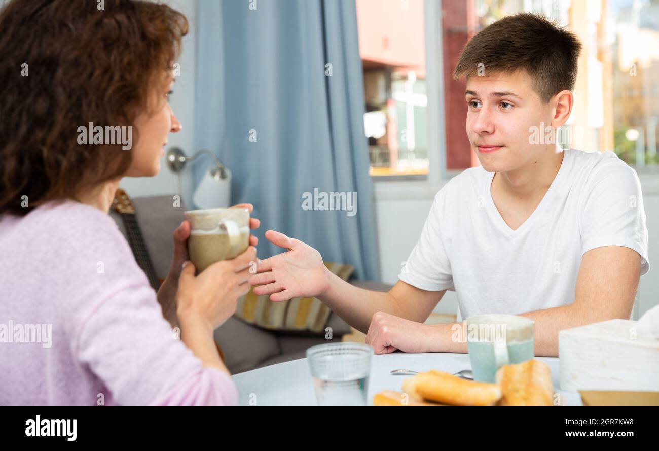 Mother and son enjoying conversation Stock Photo - Alamy