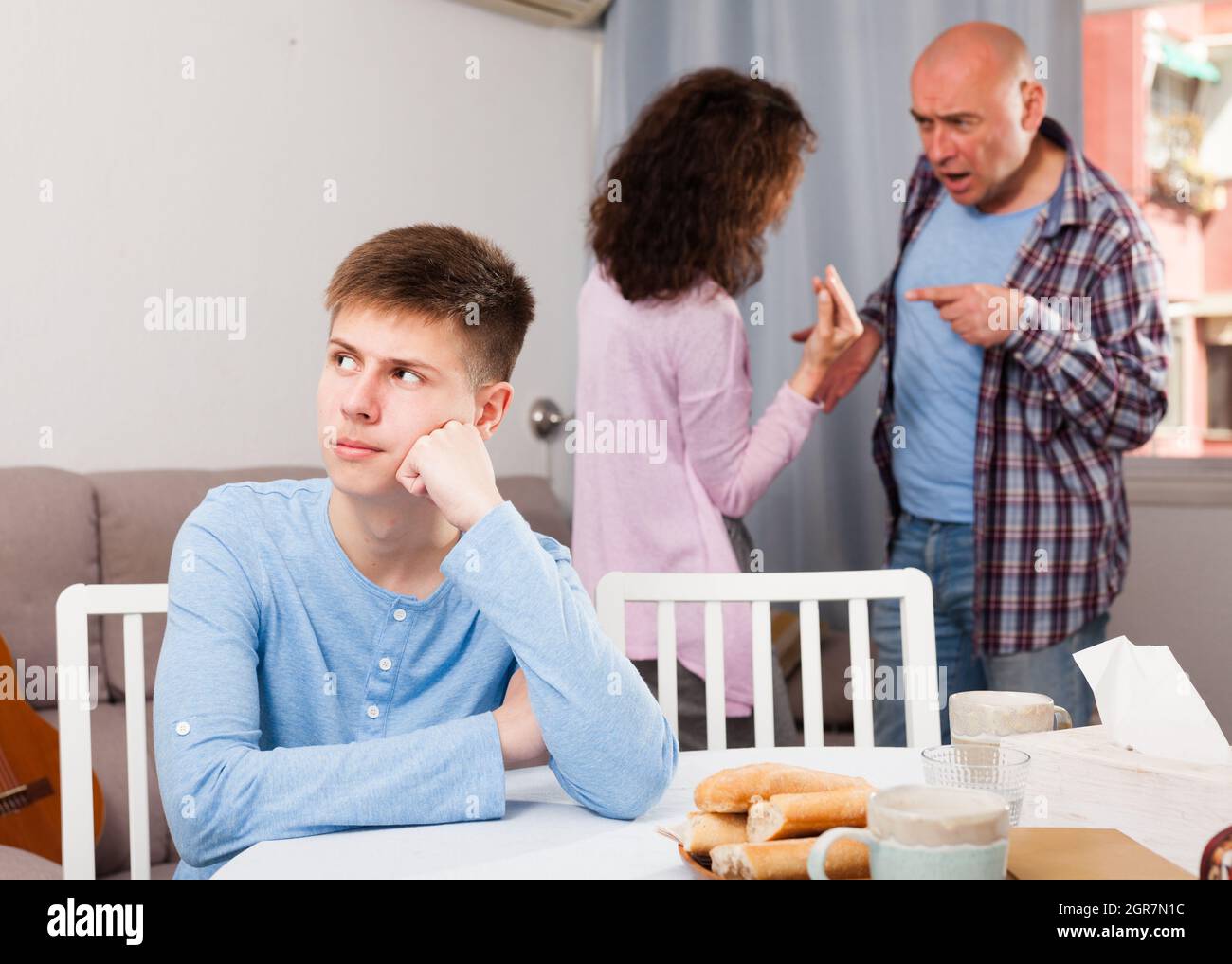 Son suffering from parents conflicts Stock Photo - Alamy