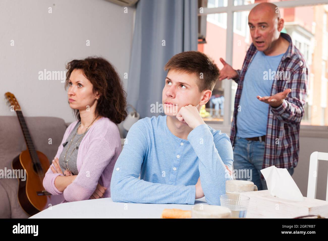 Upset teenage boy scolded by mother and father Stock Photo - Alamy