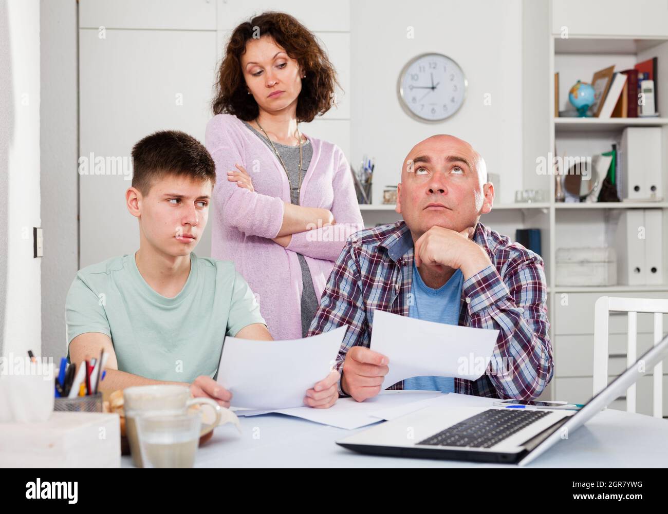 Worried family with papers Stock Photo - Alamy