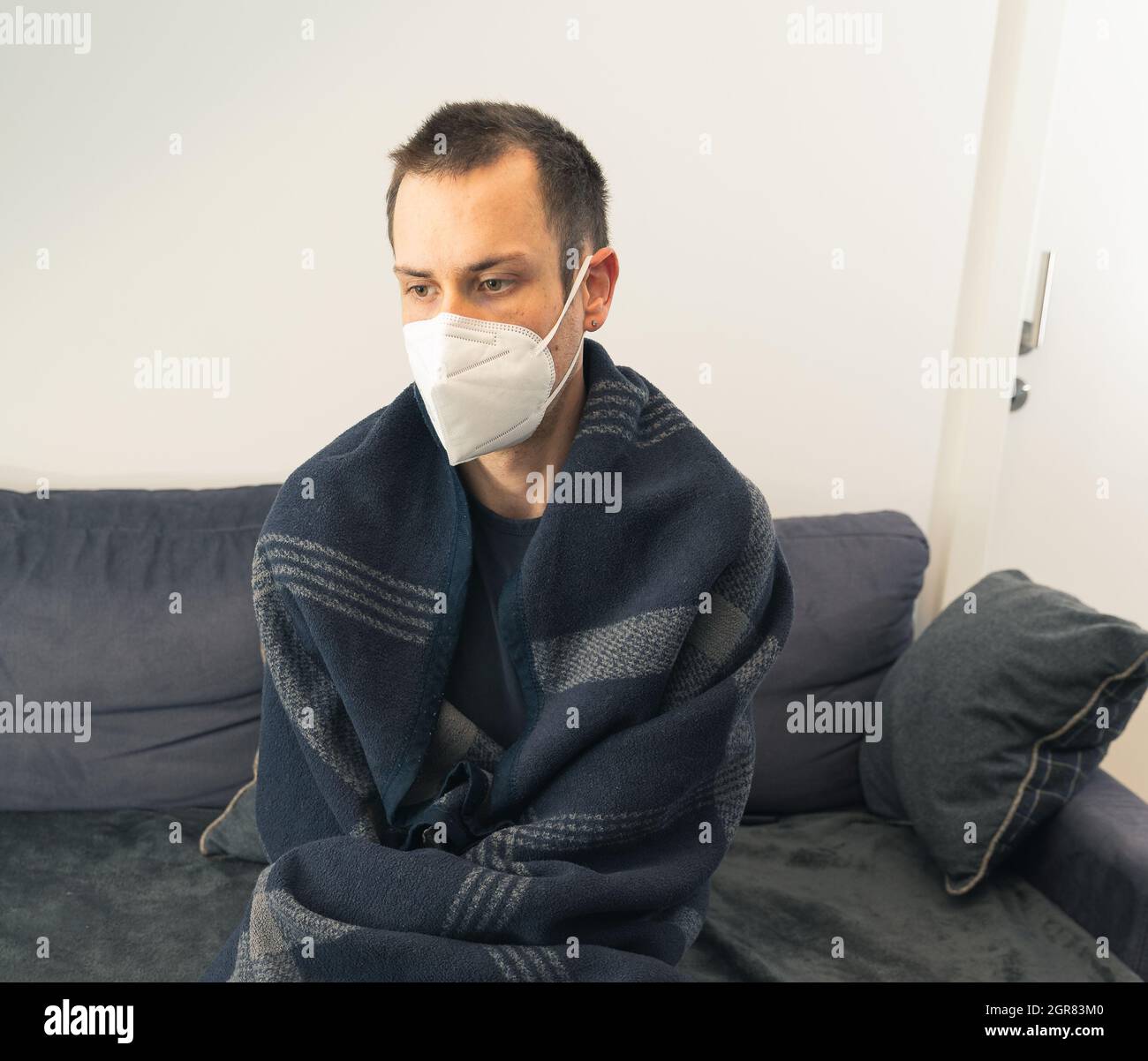Sick male wrapped in blanket hi-res stock photography and images - Alamy