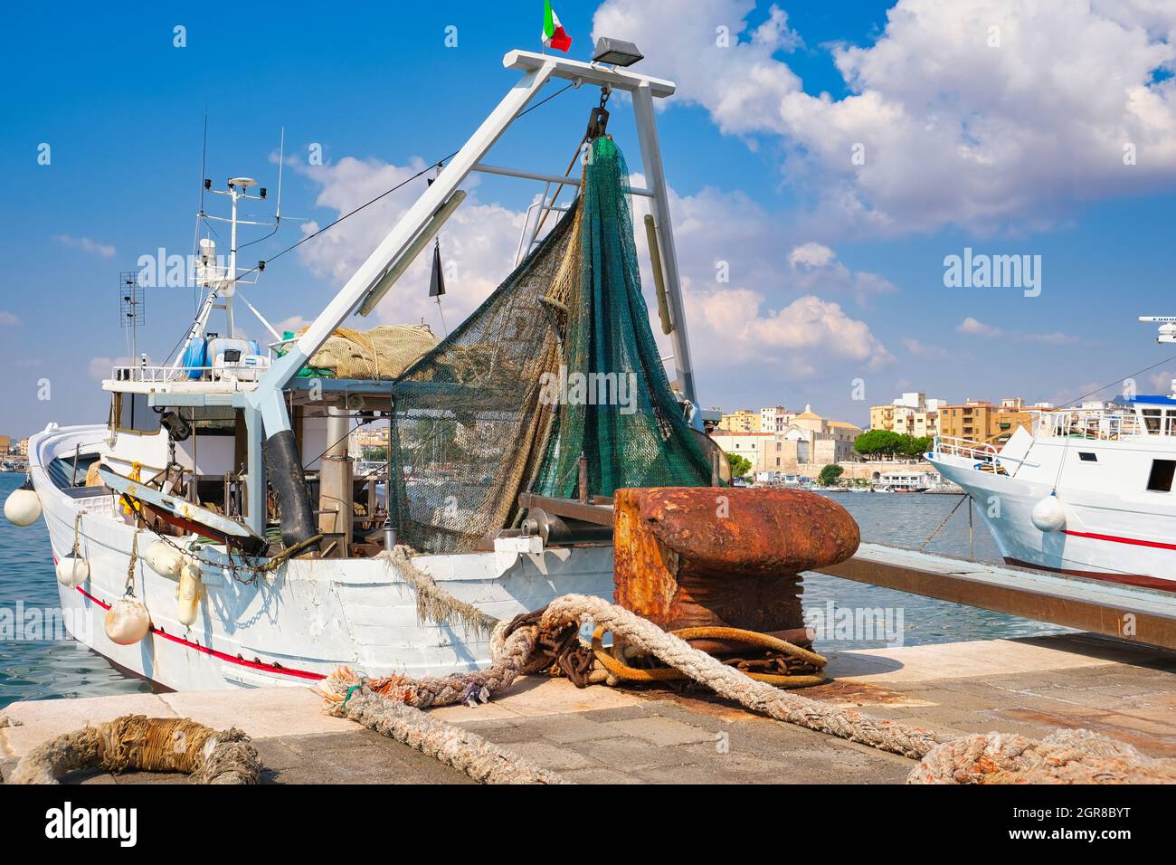 Fishing boats and nets in the harbor Stock Photo - Alamy