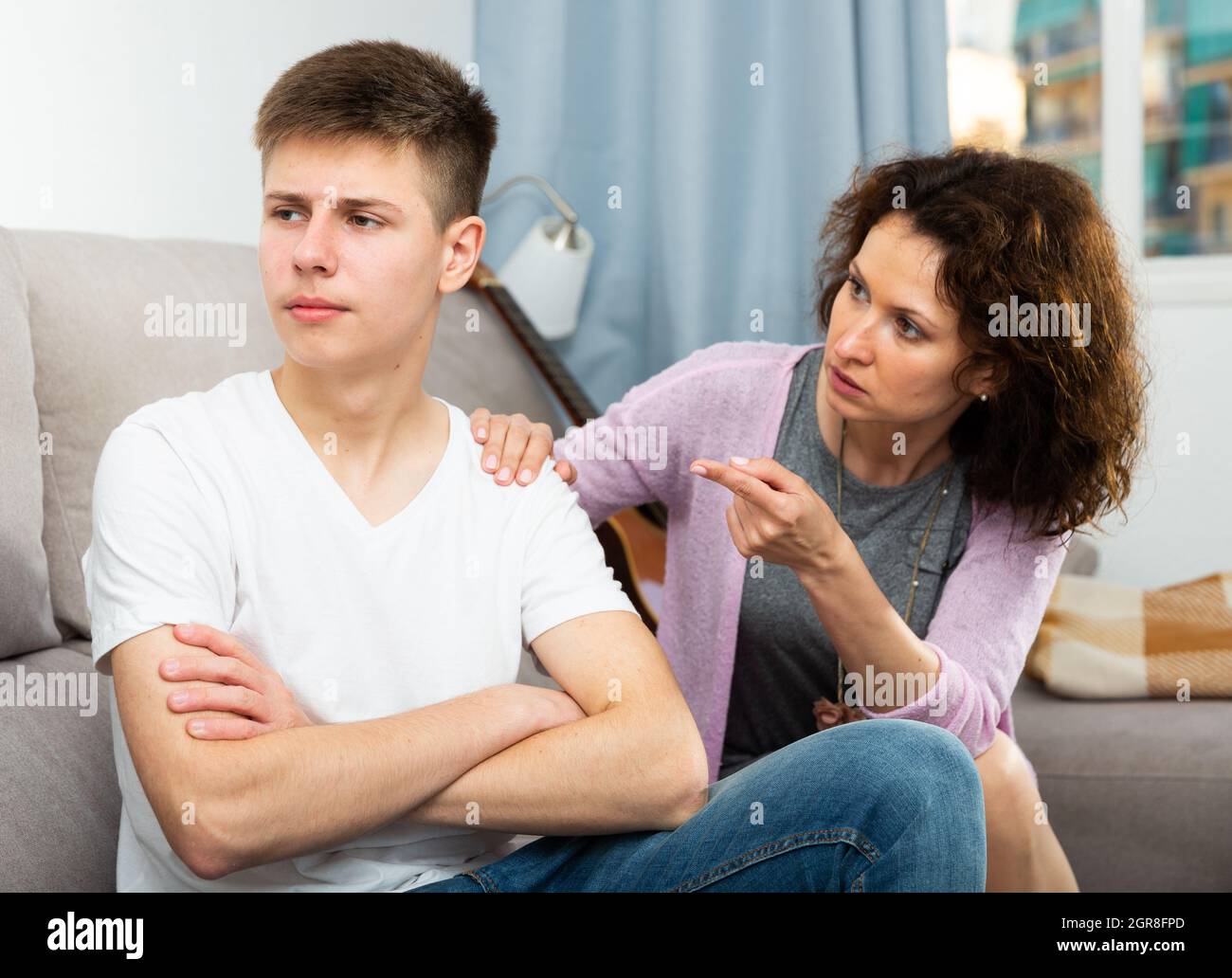 Worried mother talking to son Stock Photo - Alamy