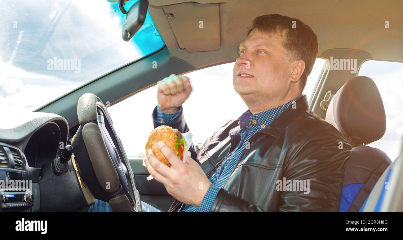 Eating food behind the wheel of a car hi-res stock photography and images - Alamy