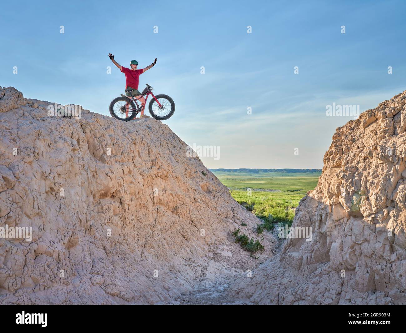 Senior man is riding a fat mountain bike in badlands of Pawnee National ...