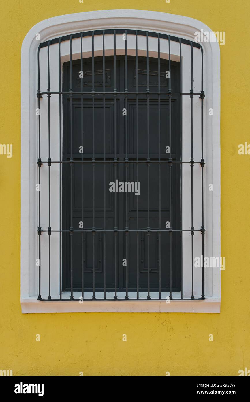 Window of a yellow facade and black doors Stock Photo - Alamy