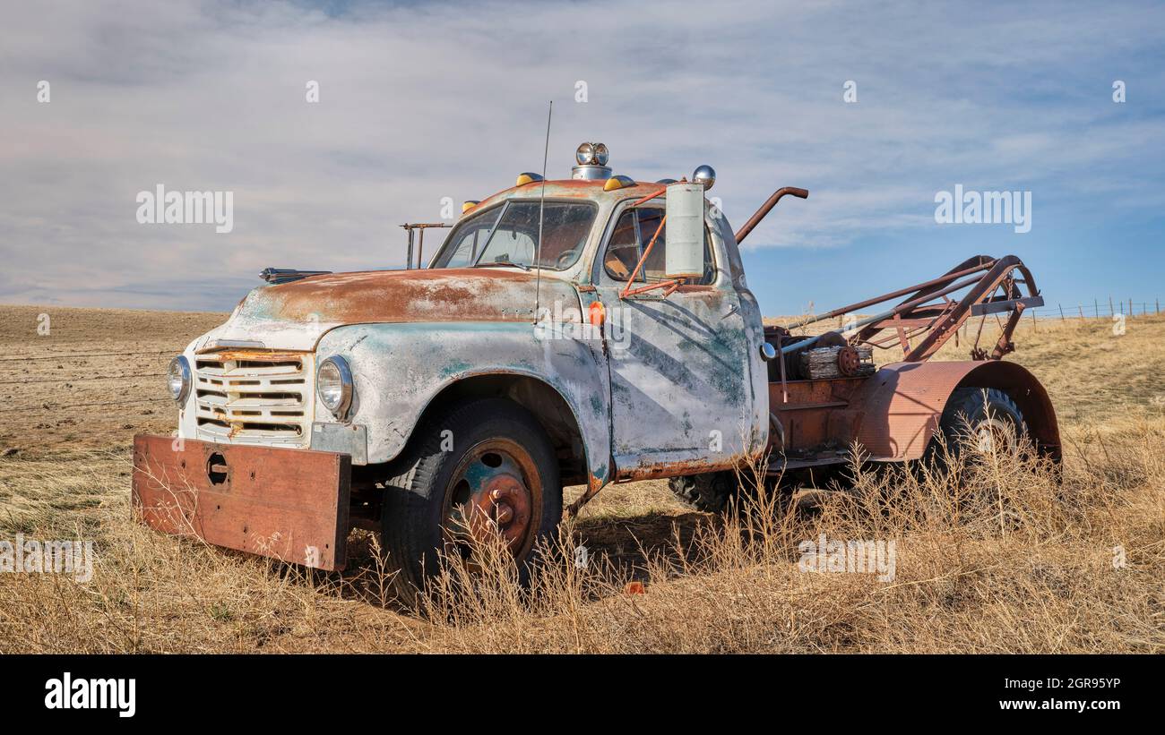 old rusty towing truck on a prairie, early spring scenery in Colorado ...