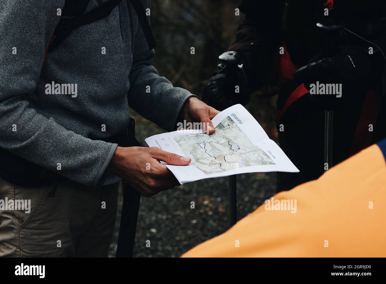 LUCHON, FRANCE - Dec 22, 2020: A closeup of scouts looking at a map ...