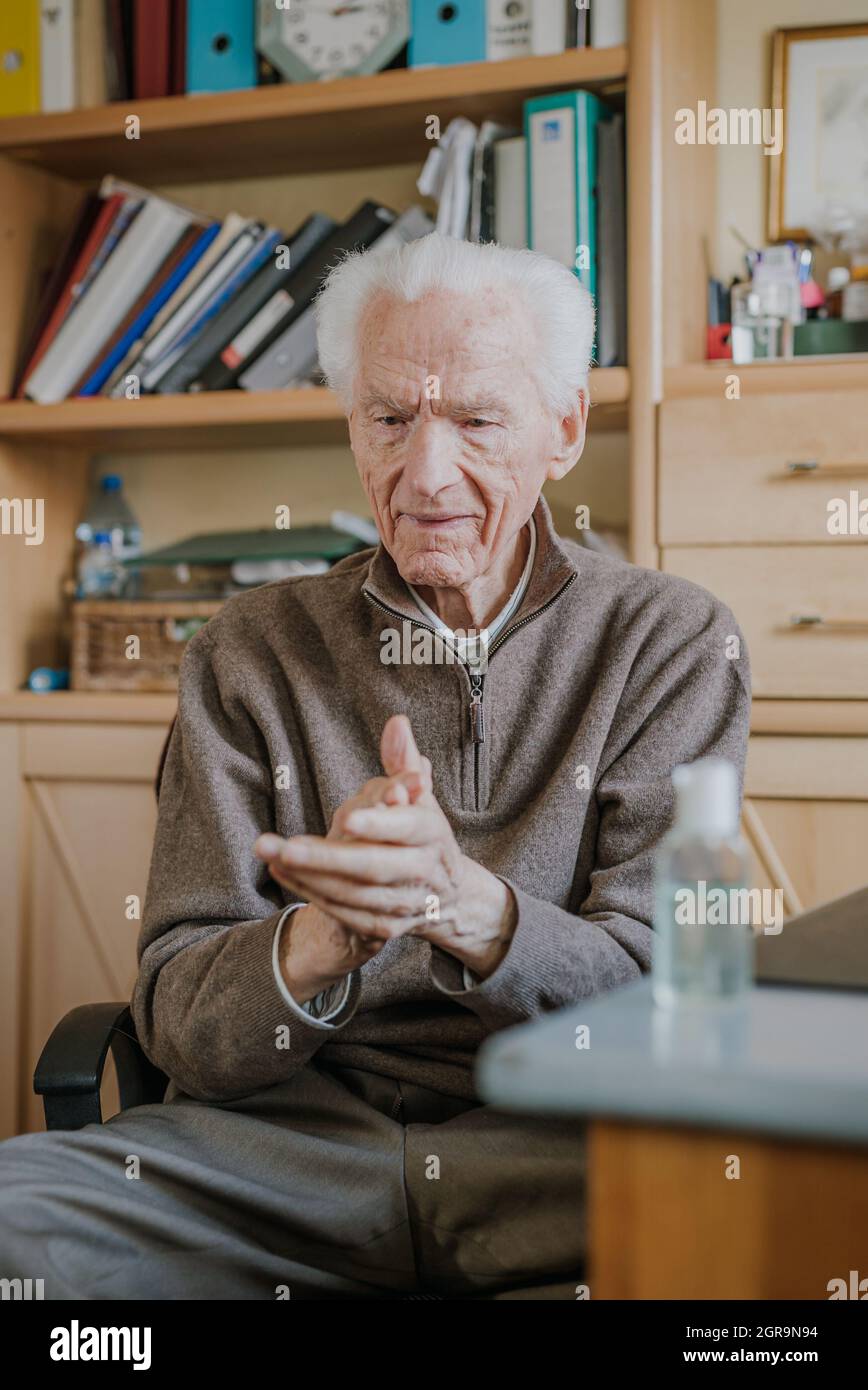 Man Sitting On Chair At Table Stock Photo - Alamy