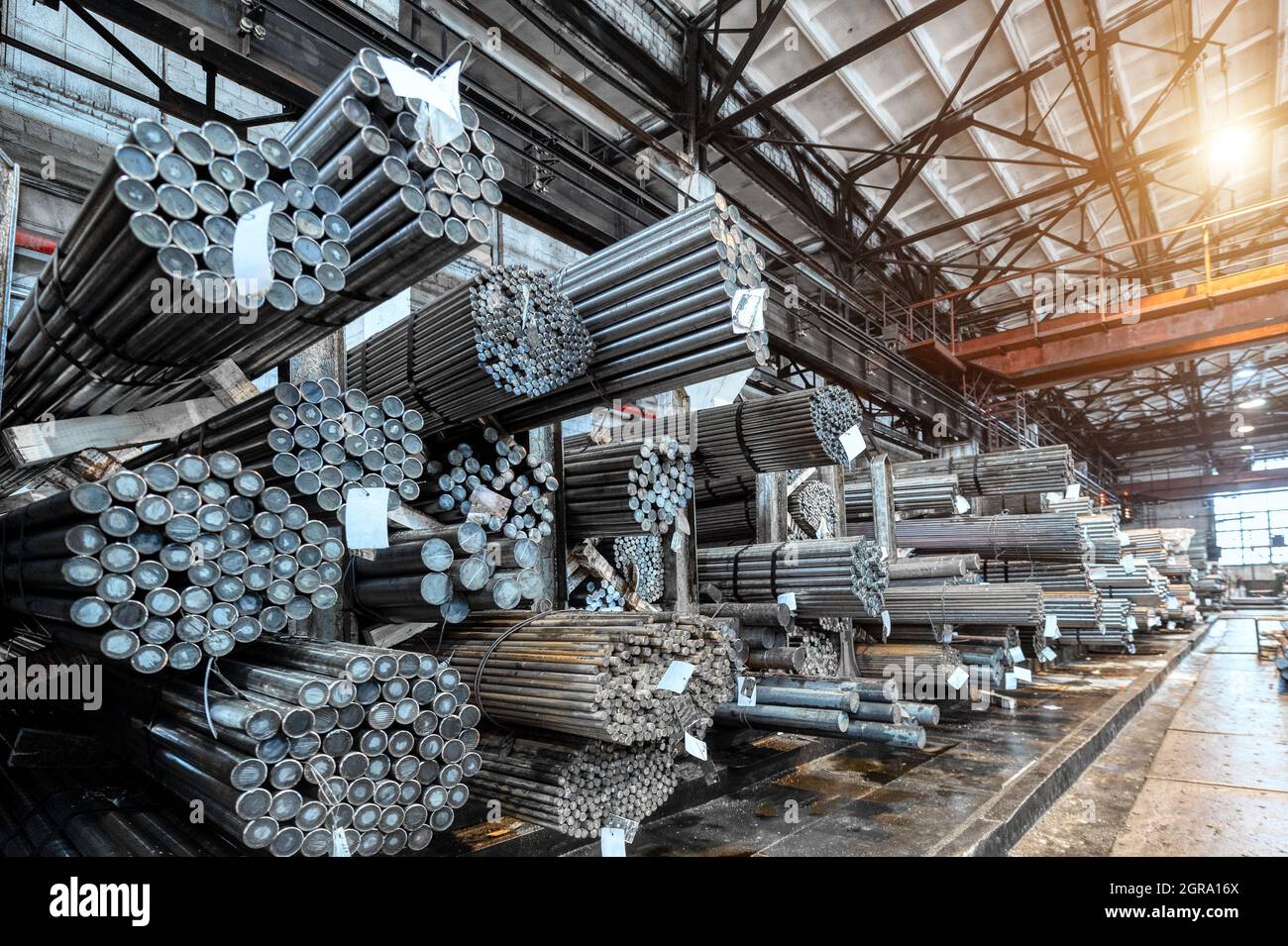 Rolled metal warehouse. Many packs of metal bars on the shelves Stock ...