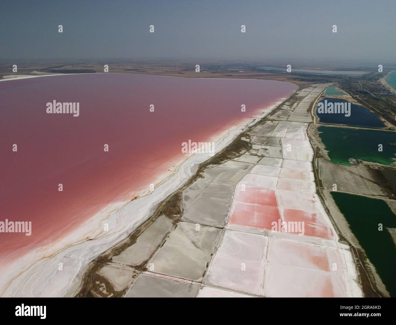 Flying over a pink salt lake. Salt production facilities saline ...