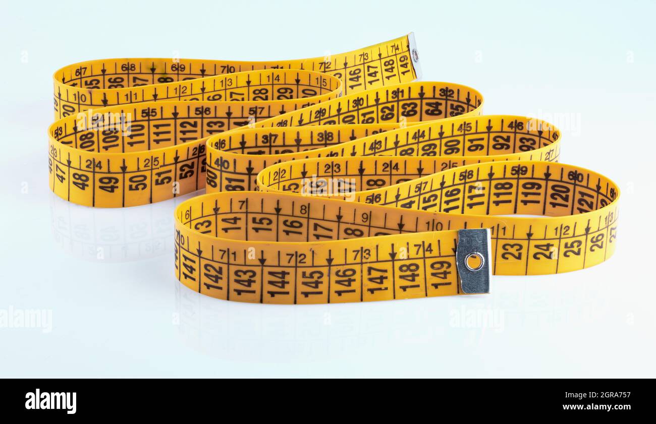 Yellow measuring tape isolated on white background Stock Photo - Alamy