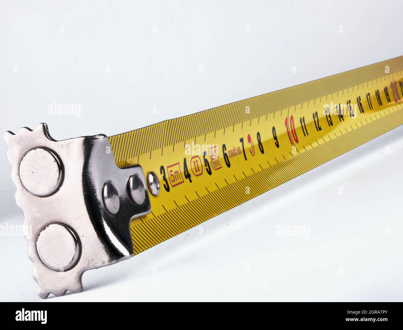 Metal measure tape isolated on white background Stock Photo - Alamy