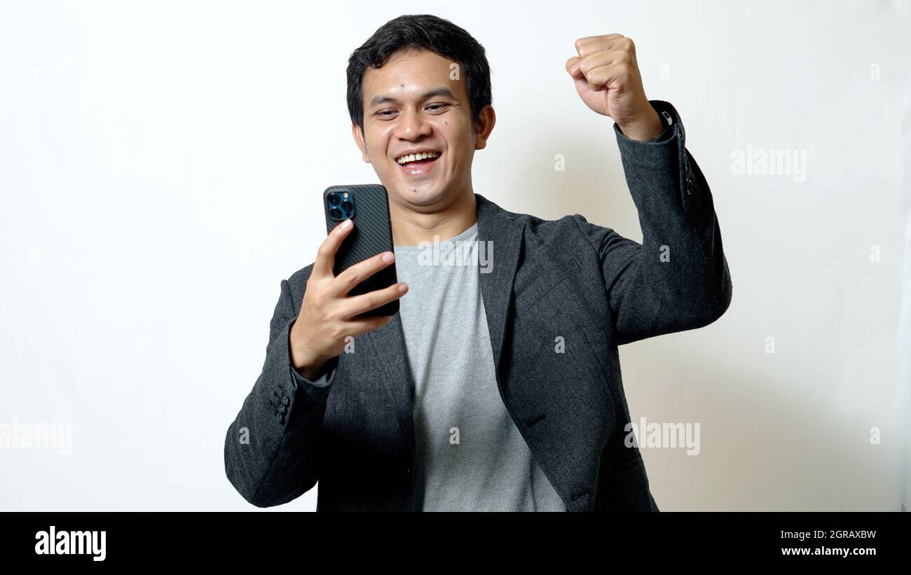 Happy Man Looking At Cell Phone Stock Photo - Alamy