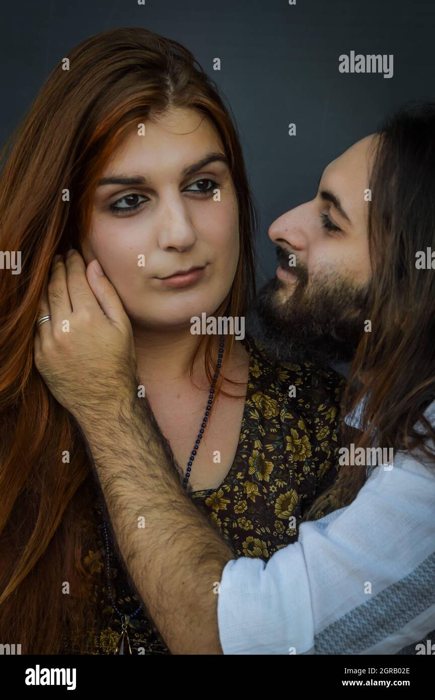 Portrait of a young couple where the young man with beard and long hair ...