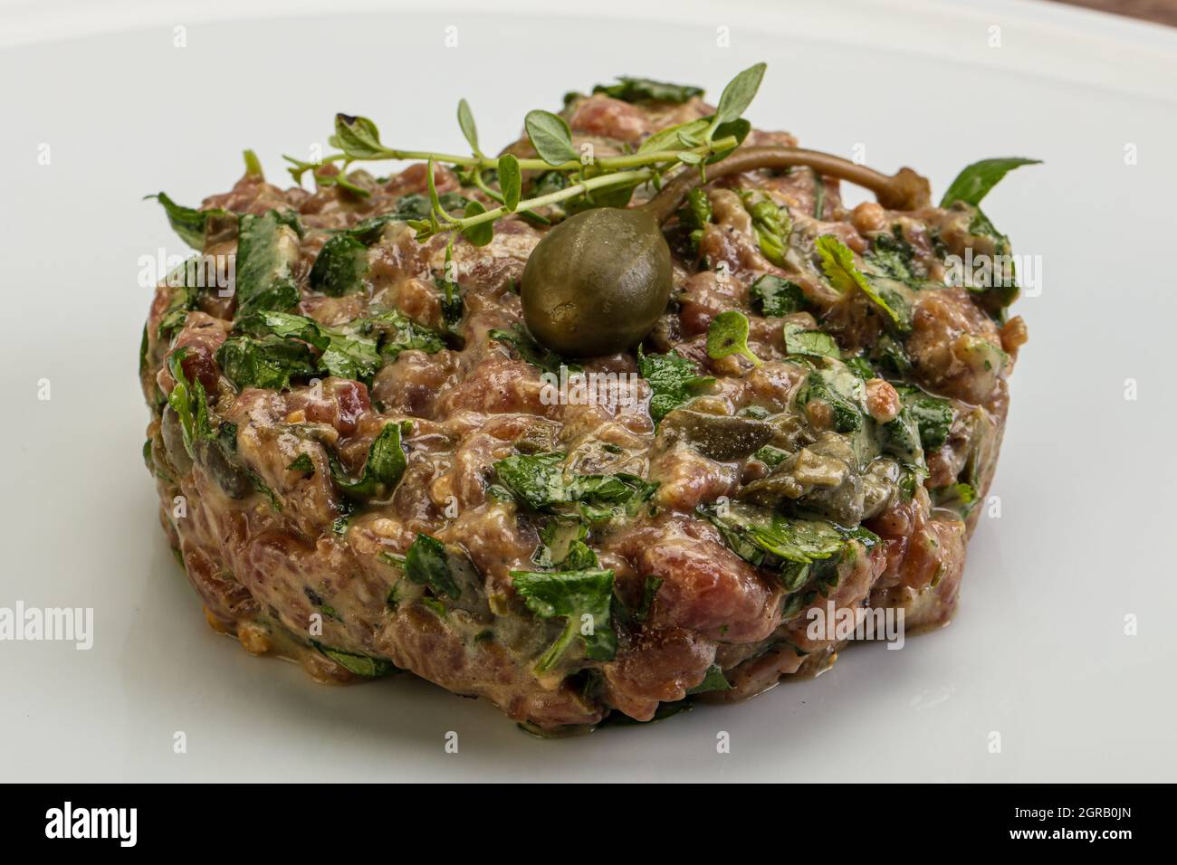 Raw beef tartar snack with capers Stock Photo - Alamy