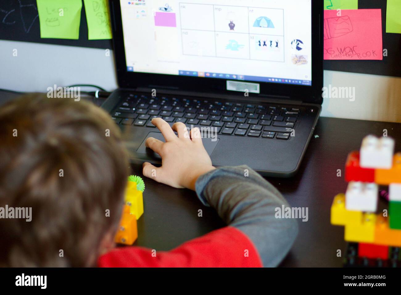 Child laptop looking over shoulder hi-res stock photography and images ...