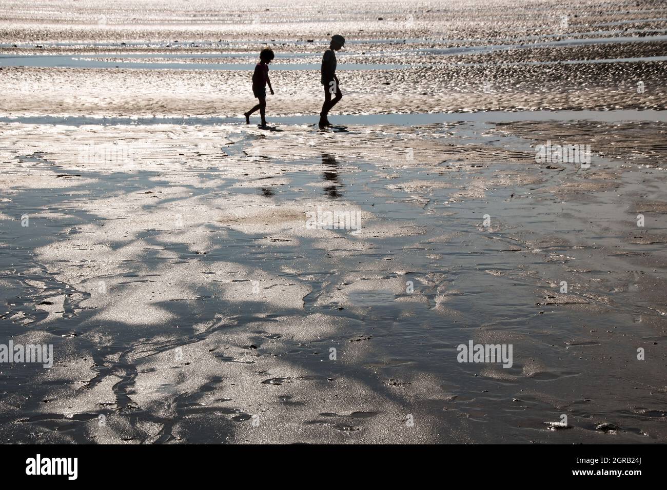 People Walking On Beach Stock Photo - Alamy