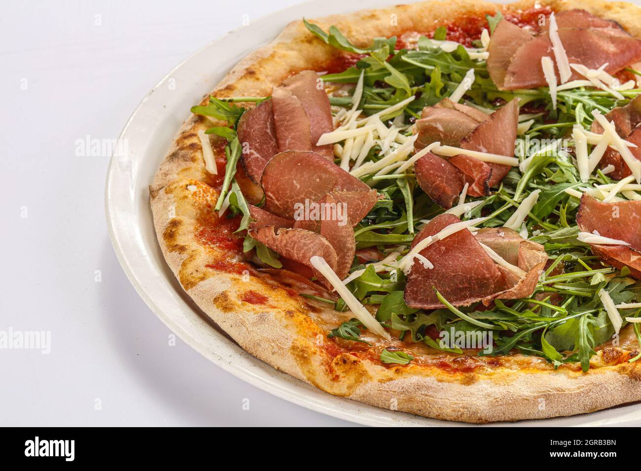 Italian pizza with prosciutto, cheese and ruccola Stock Photo - Alamy