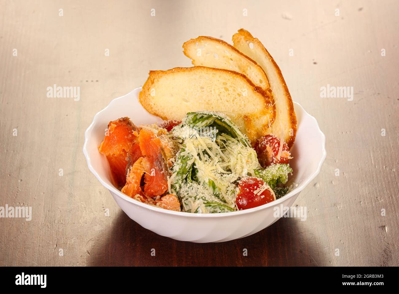 Caesar salad with salmon fish and cheese Stock Photo - Alamy