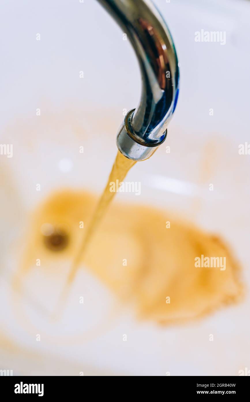 Rusty water flows from the tap into the bathtub Stock Photo - Alamy