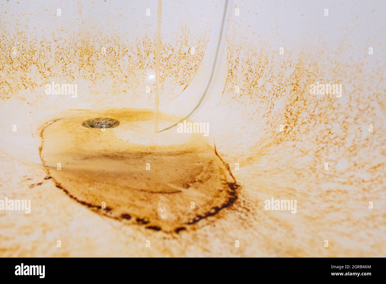 Rusty water flows from the tap into the bathtub Stock Photo - Alamy