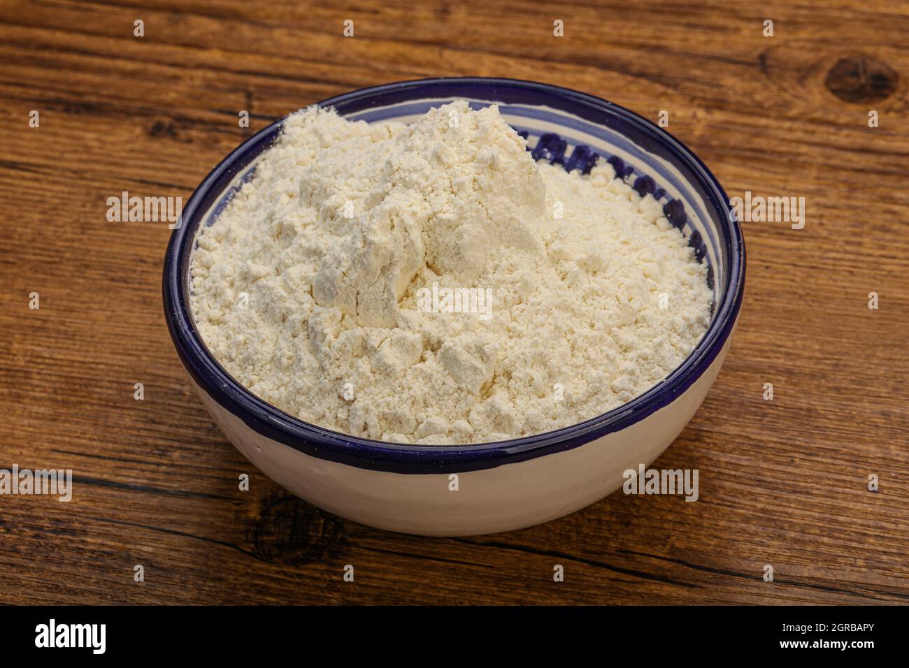 Wheat flour heap in the bowl for cooking Stock Photo - Alamy