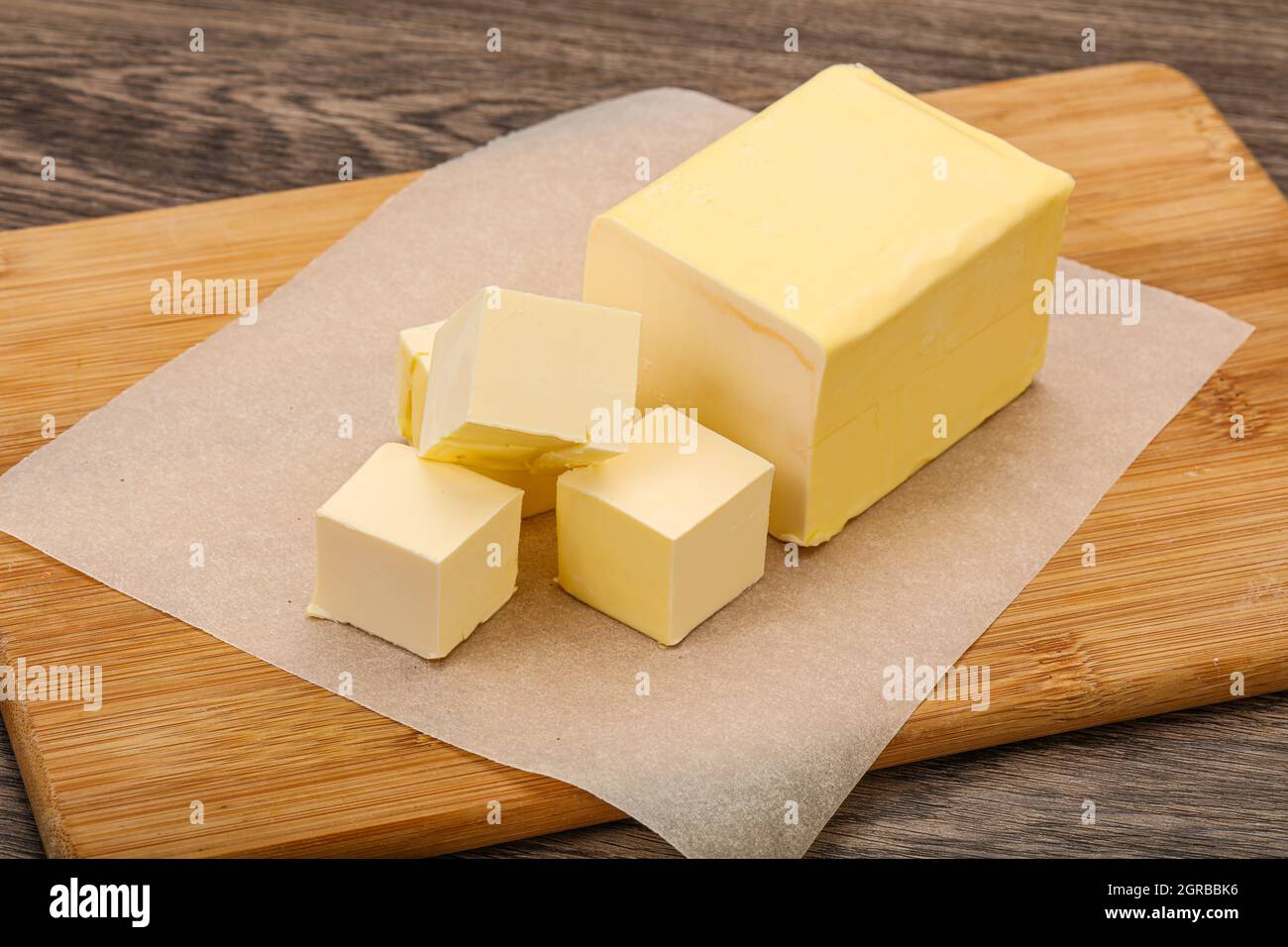 Dairy natural yellow butter piece over board Stock Photo - Alamy