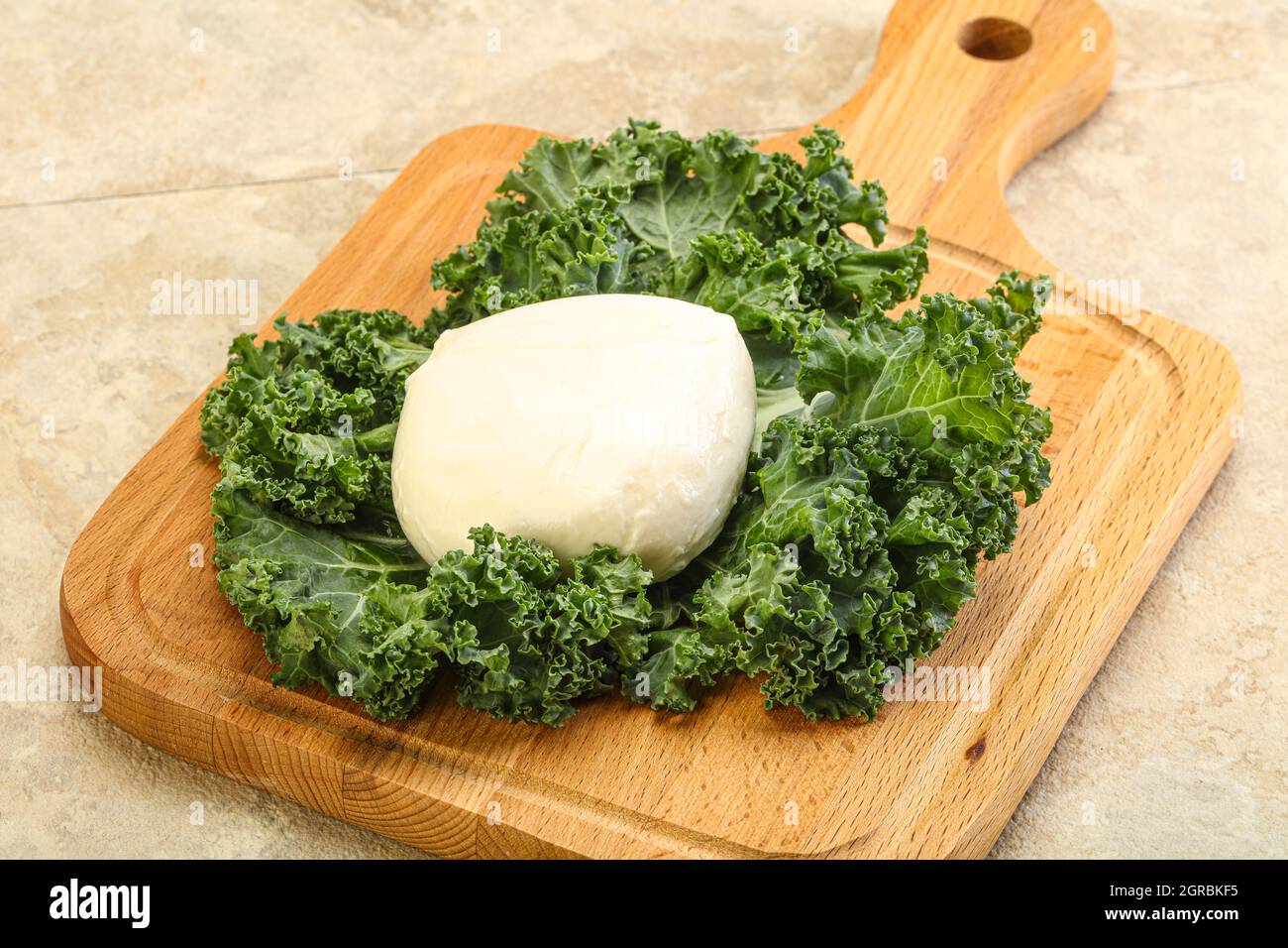 Soft Italian mozzarella cheese over board Stock Photo - Alamy