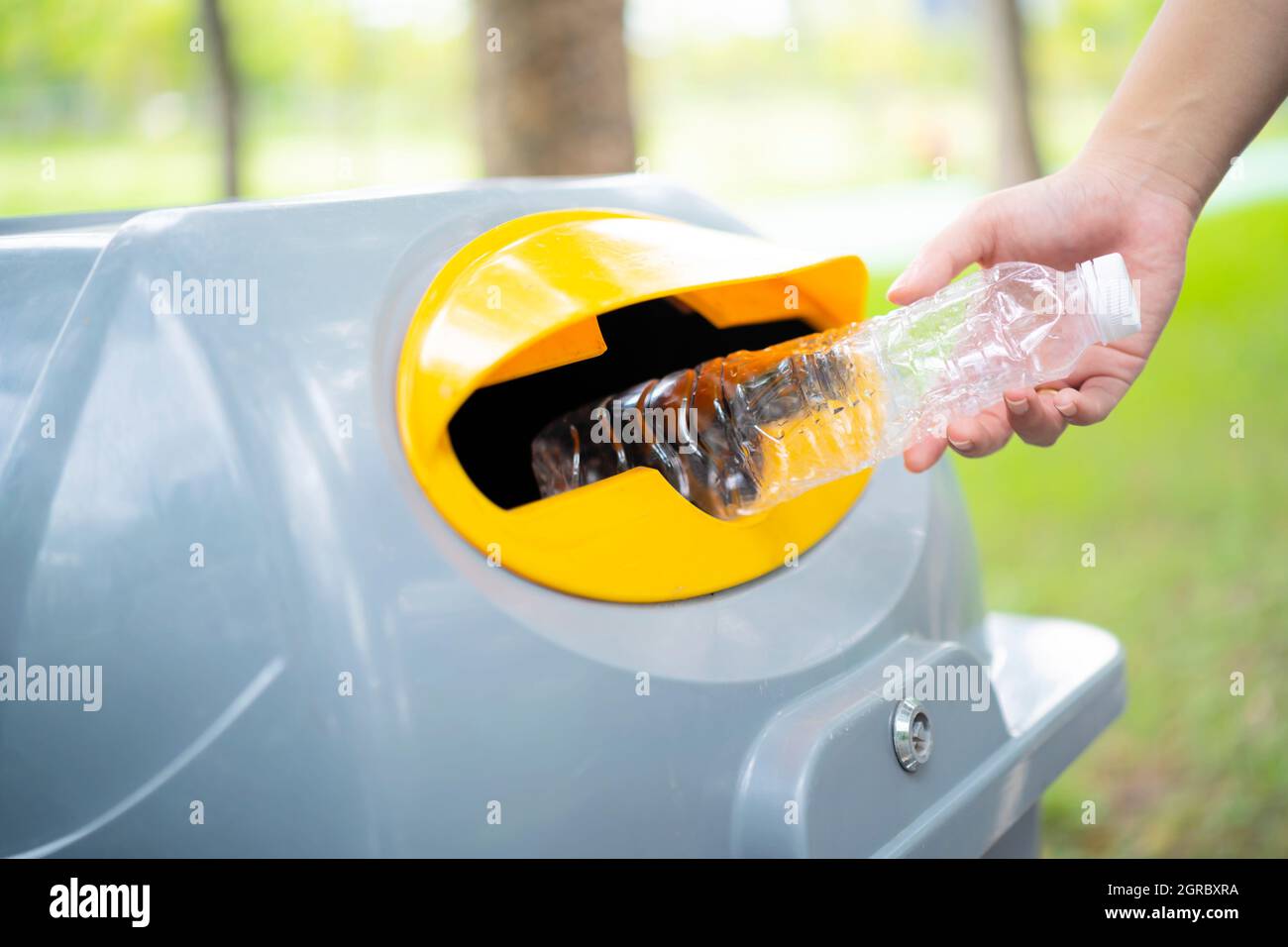 Close Up Hand Throwing Empty Plastic Bottle Into The Trash Recycling Concept Stock Photo - Alamy
