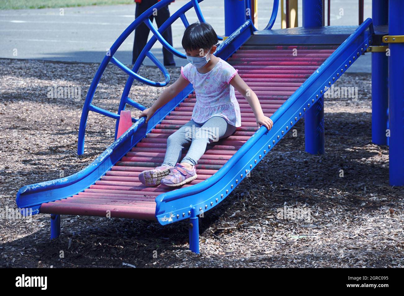 Playground slide man sitting hi-res stock photography and images - Alamy