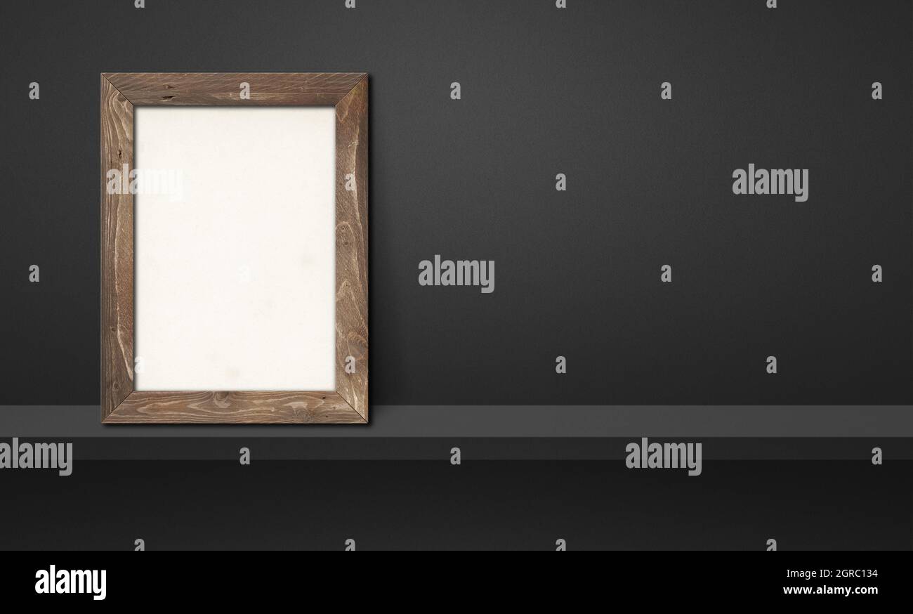 Wooden picture frame leaning on a black shelf. 3d illustration. Blank ...