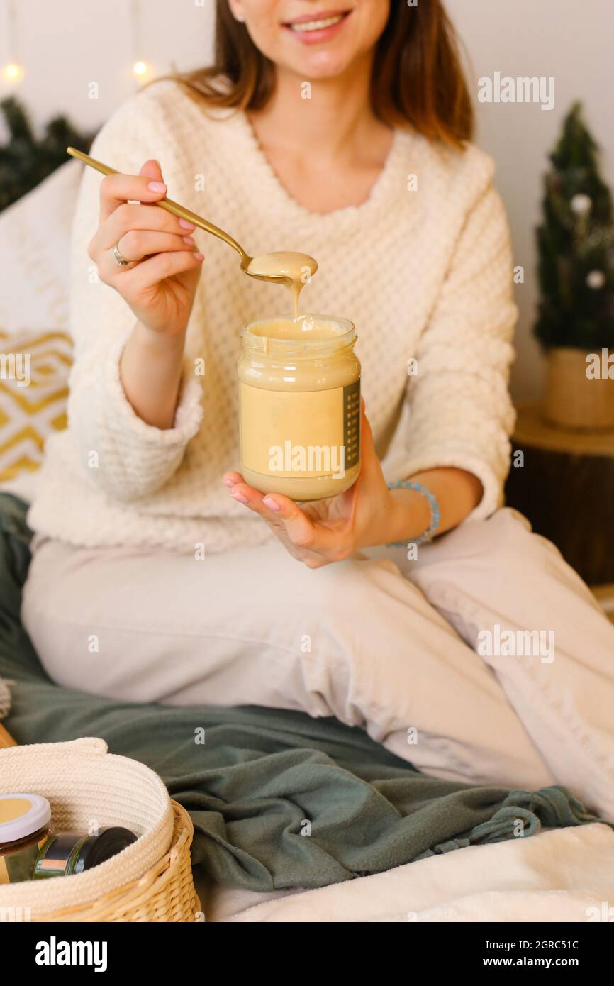 Woman eating peanut butter hi-res stock photography and images - Alamy
