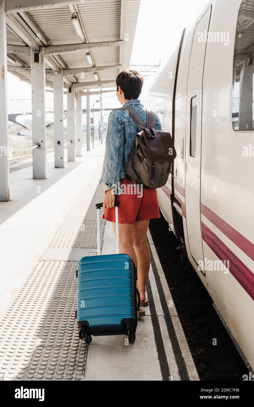Rear View Of Woman Standing On Train Stock Photo - Alamy