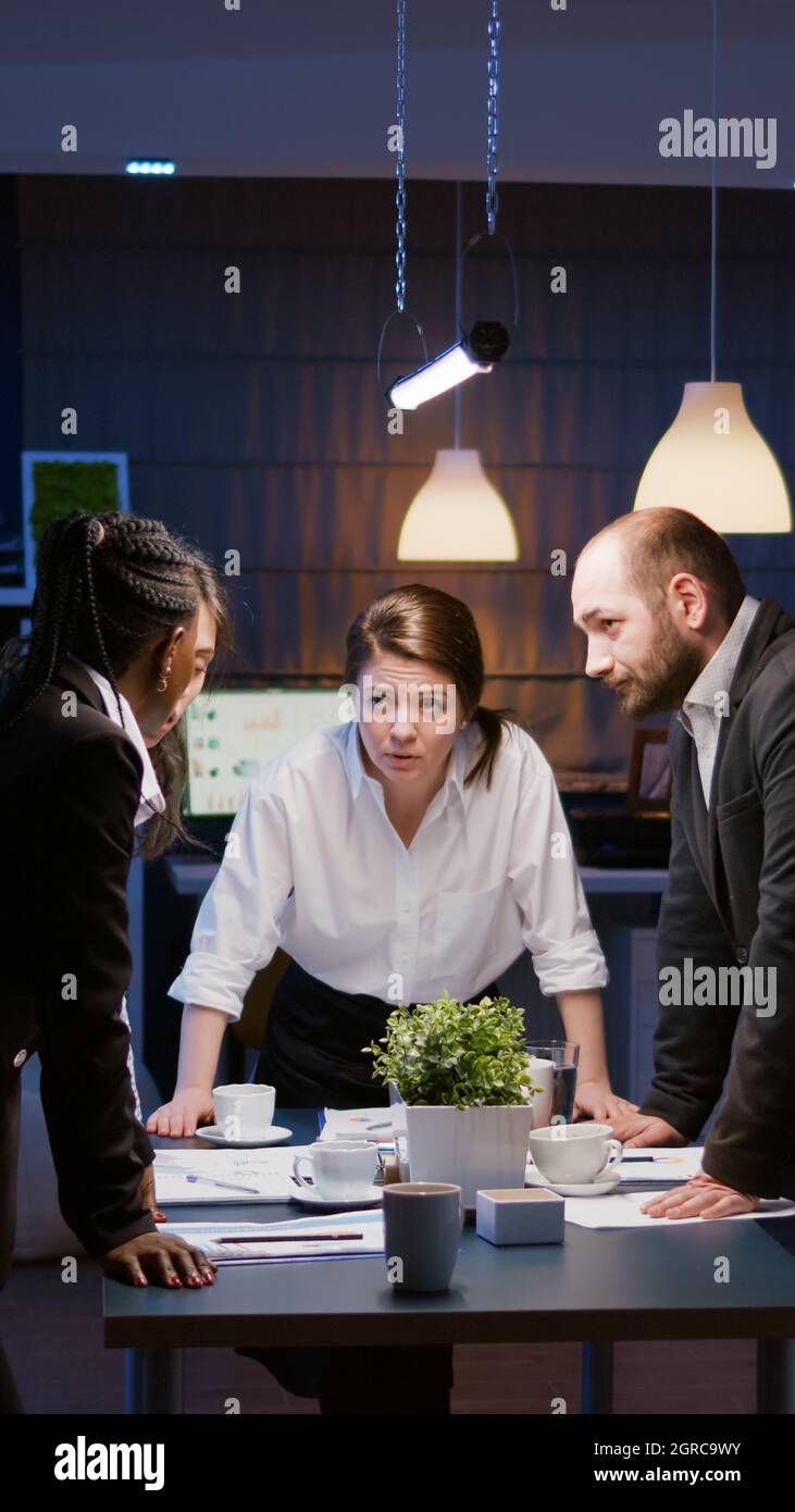 Diverse multi ethnic teamwork standing around table brainstorming ...