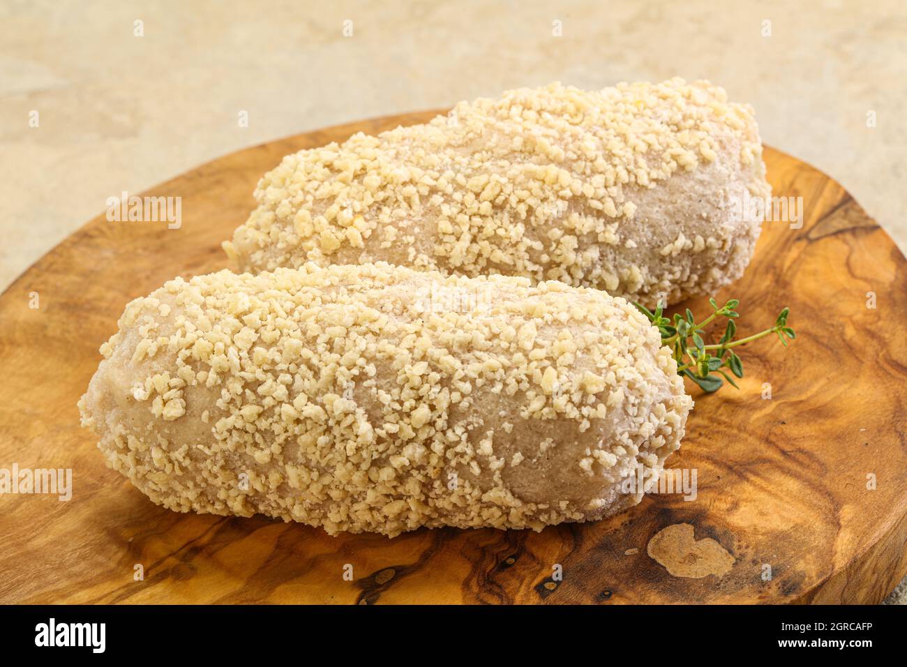 Raw breaded chicken cutlet for roast Stock Photo - Alamy