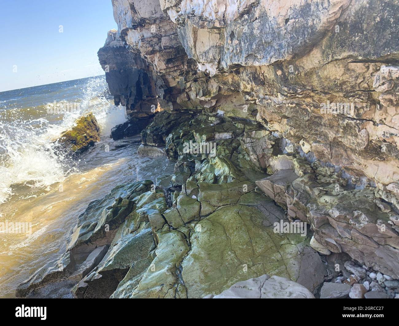 sea rock is breaking powerful wave on rocks Stock Photo - Alamy