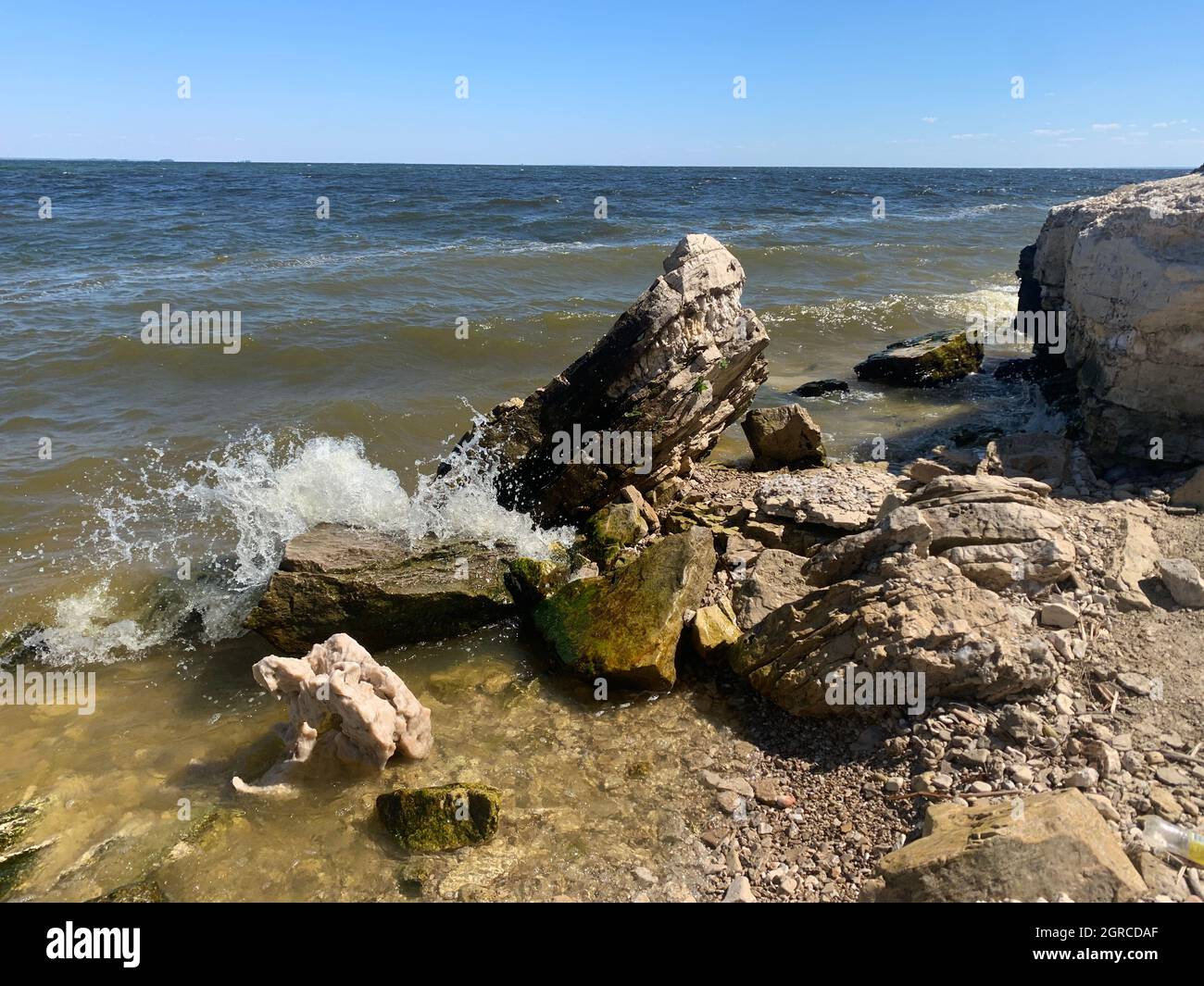 sea rock is breaking powerful wave on rocks Stock Photo - Alamy