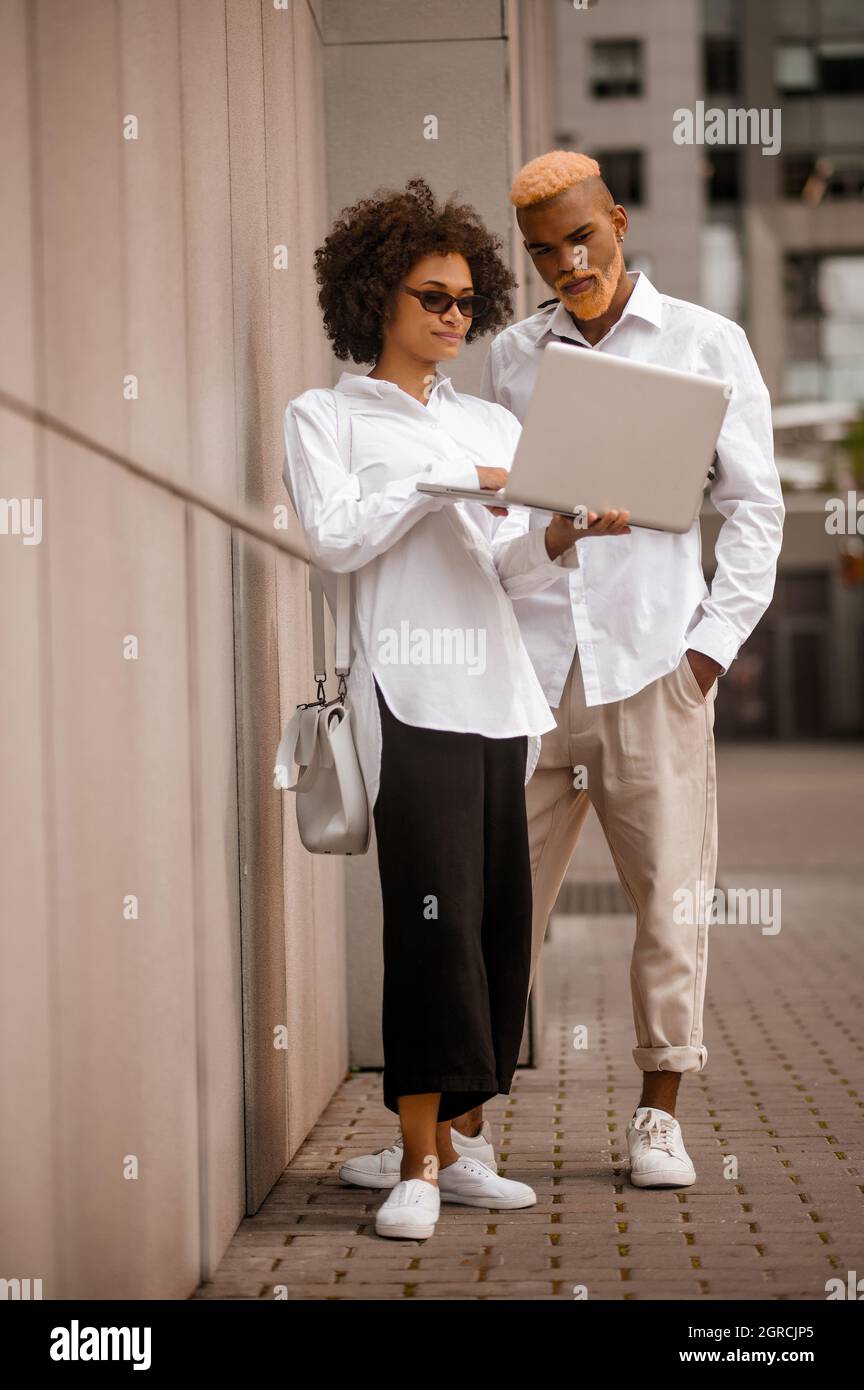 Two colleagues discussing something and looking involved Stock Photo ...