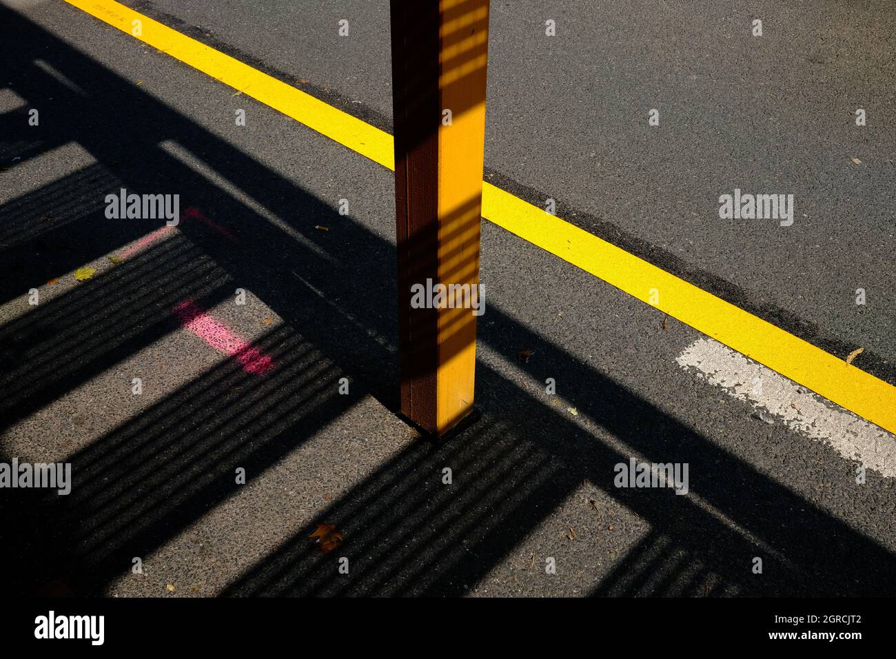 Yellow Marking On Road In Sunlight Stock Photo - Alamy