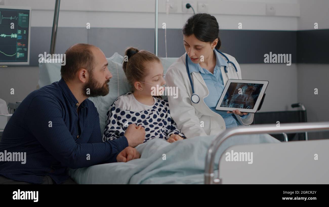 Practitioner pediatrician woman doctor pointing radiography expertise ...