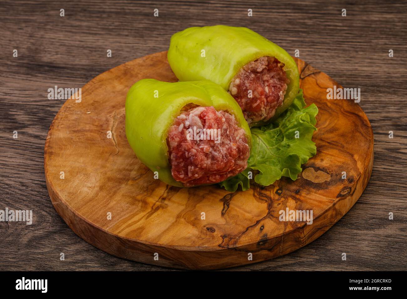Raw stuffed green bell pepper with meat Stock Photo - Alamy