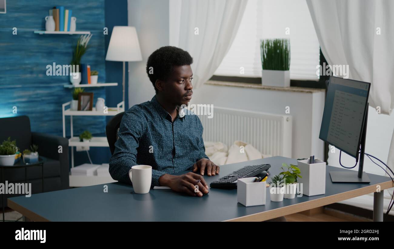 Black african american freelancer taking notes on notepad and looking ...