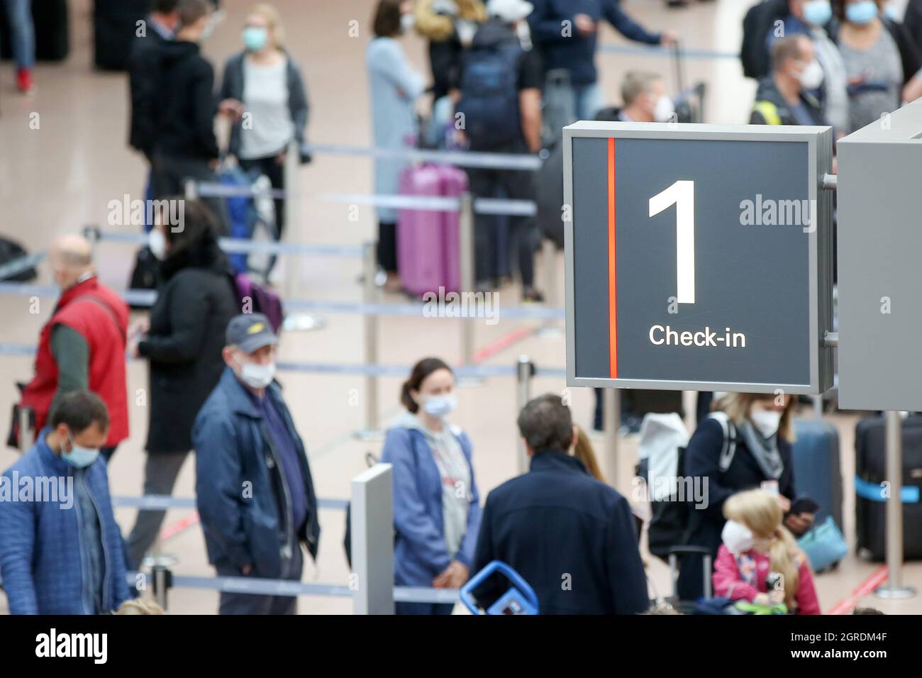 Hamburg, Germany. 01st Oct, 2021. Travellers queue at a check-in desk ...