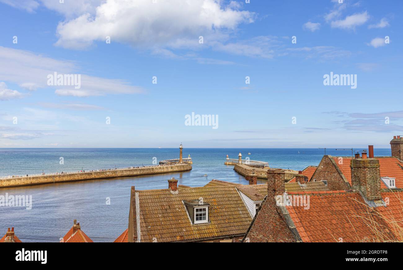 Two piers with lighthouses form a harbour entrance and the open sea is ...