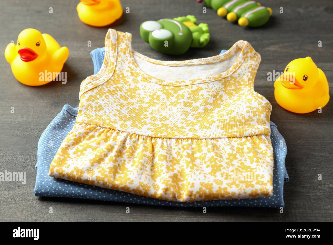 Concept of cute baby clothes on dark textured background Stock Photo ...