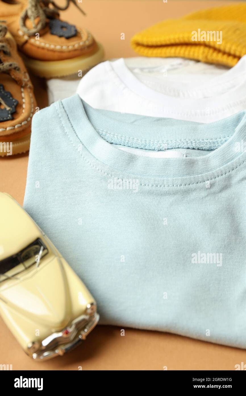Concept of baby clothes on beige background Stock Photo - Alamy