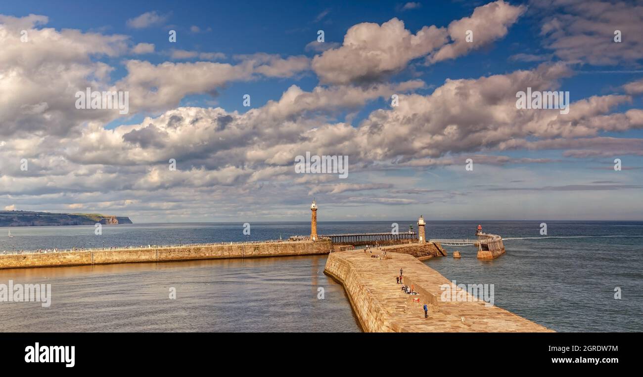 Two piers with lighthouses form a harbour entrance and the open sea is ...